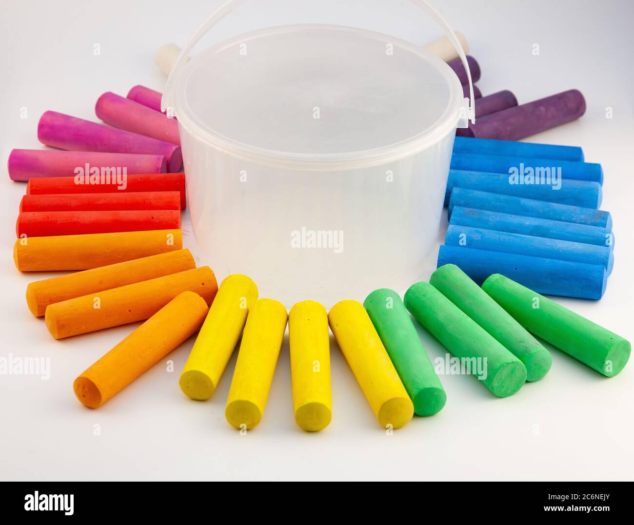 Colorful chalks in plastic bucket isolated on white background. Close ...
