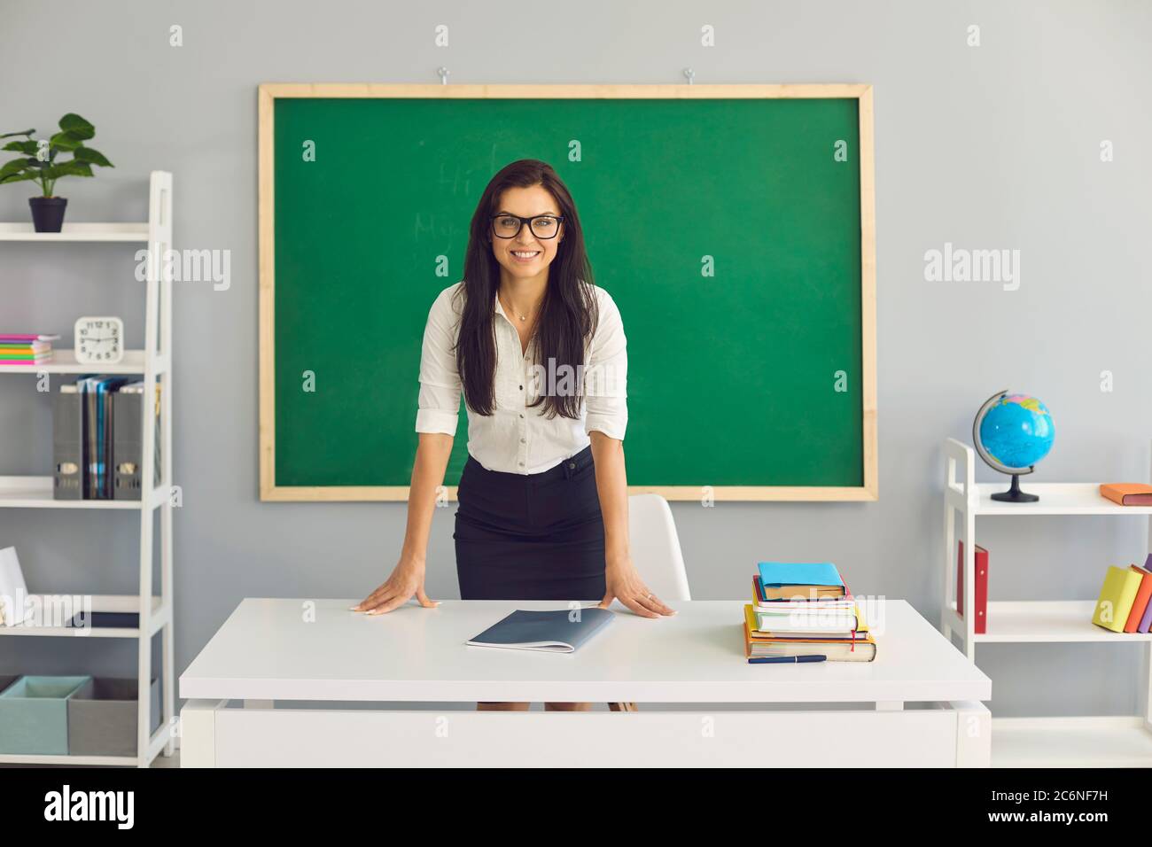 Teacher with glasses in a modern school class Stock Photo - Alamy