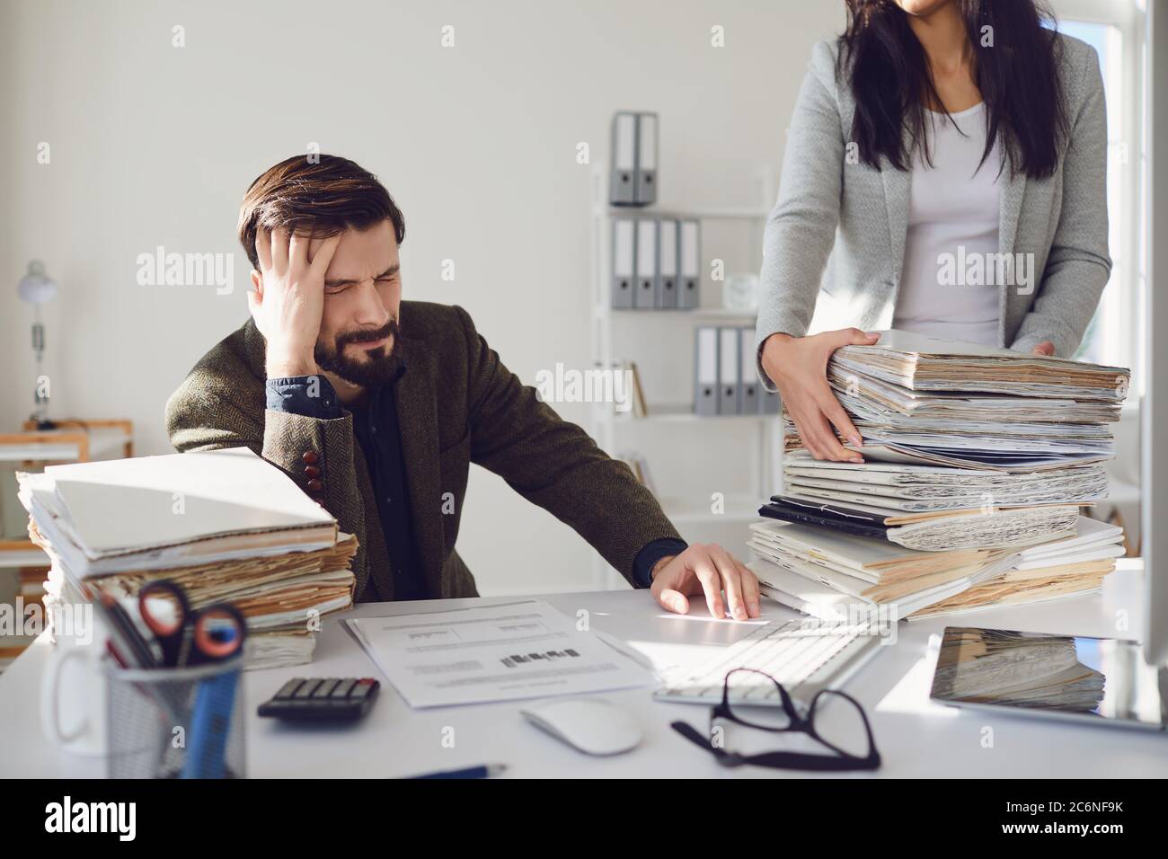 Worker businessman tired upset indignant unhappy sitting at workplace ...
