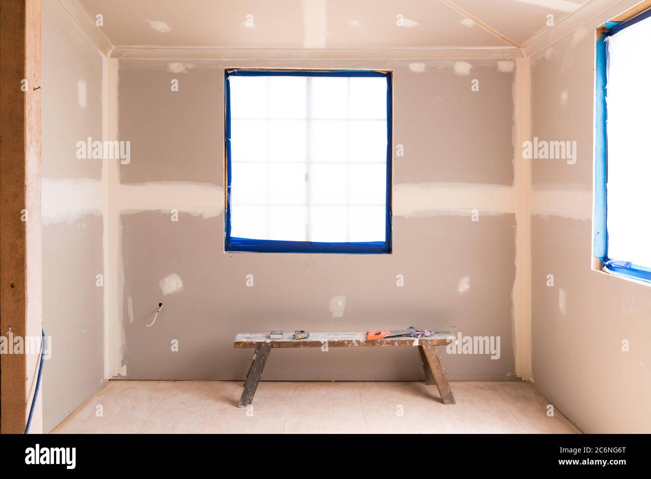 Windows masked with plastic sheeting in preparation for painting during ...