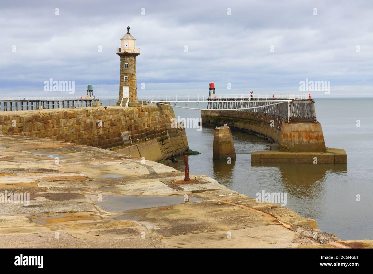 View of Whitby east Lighthouse and the footbridge leading to the pier ...