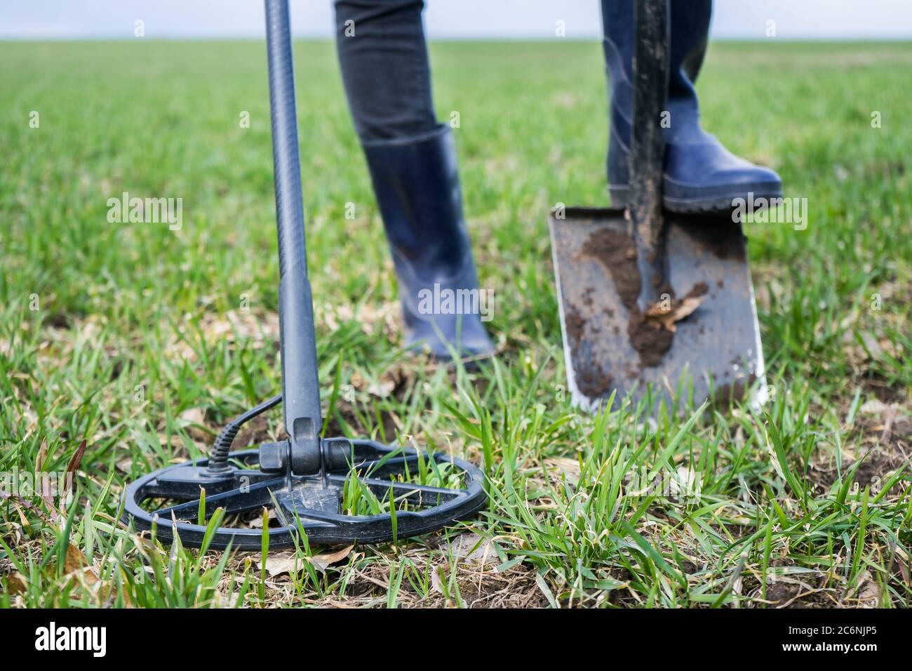 girl archaeologist or metal digger is looking for coins or metal Stock ...