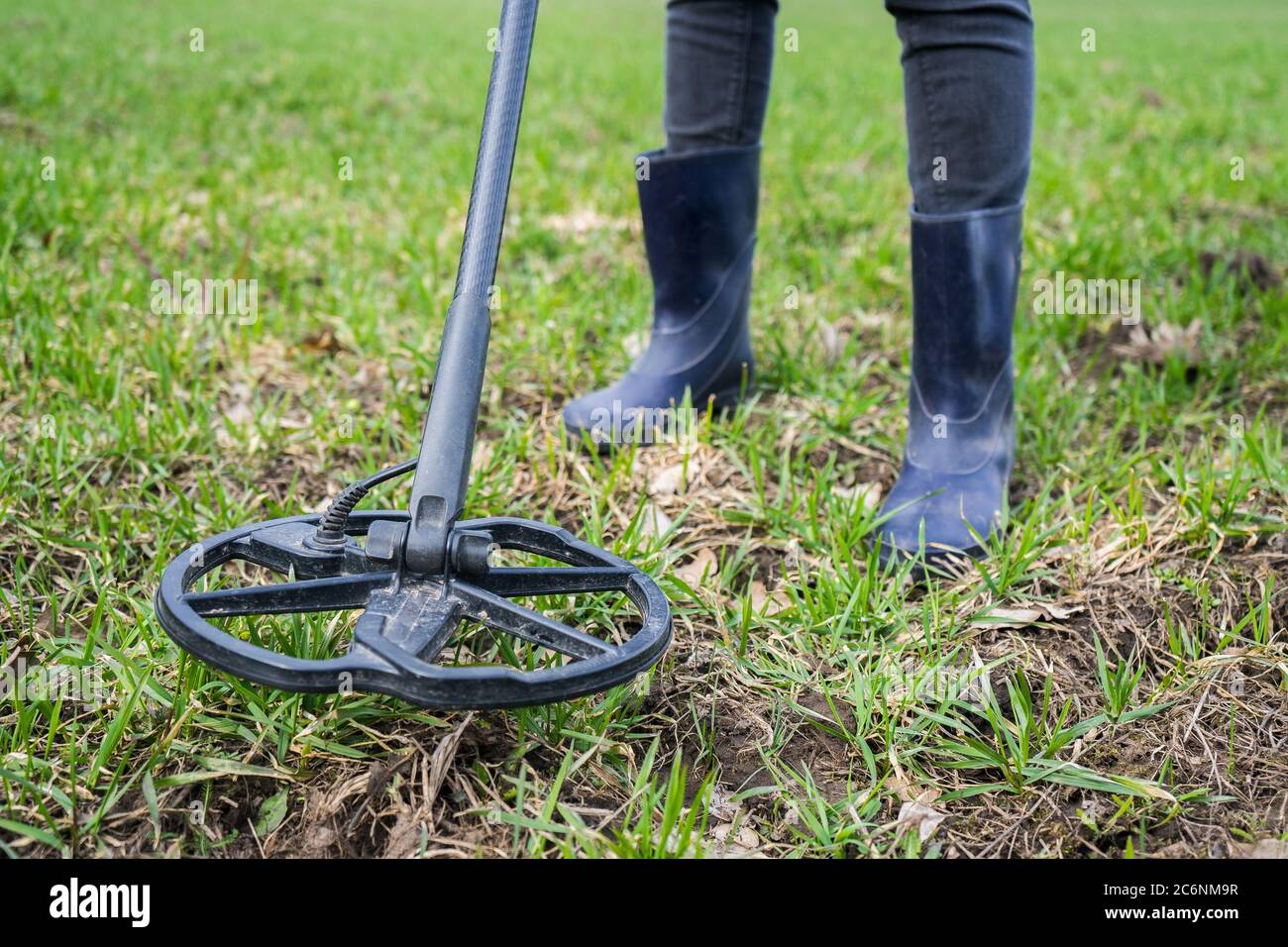girl archaeologist or metal digger is looking for coins or metal Stock ...