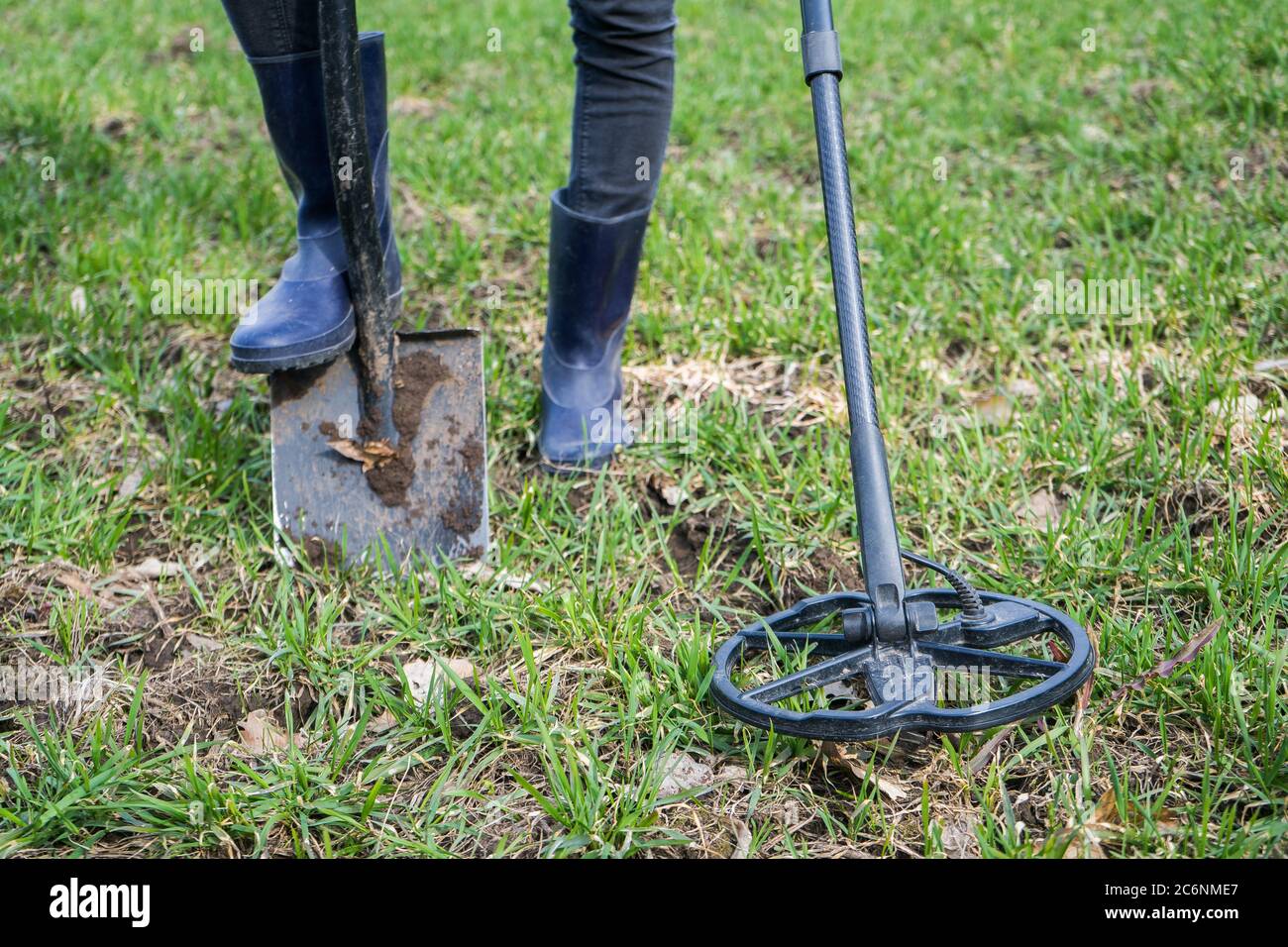 girl archaeologist or metal digger is looking for coins or metal Stock ...