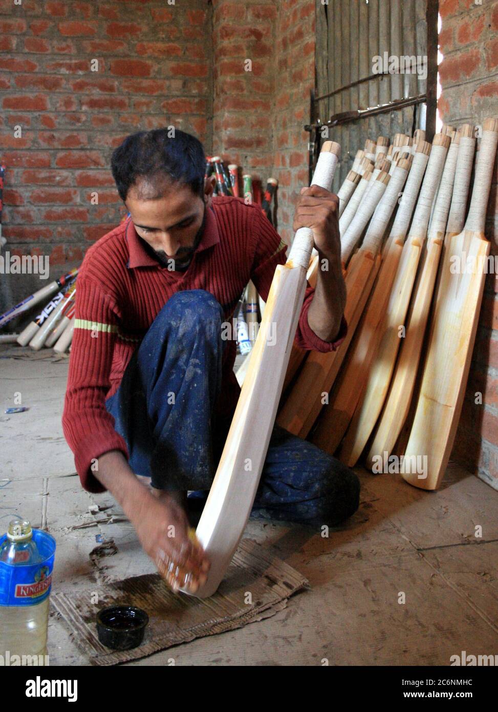 A Kashmiri craftsman polishing the bats inside a bat manufacturing ...