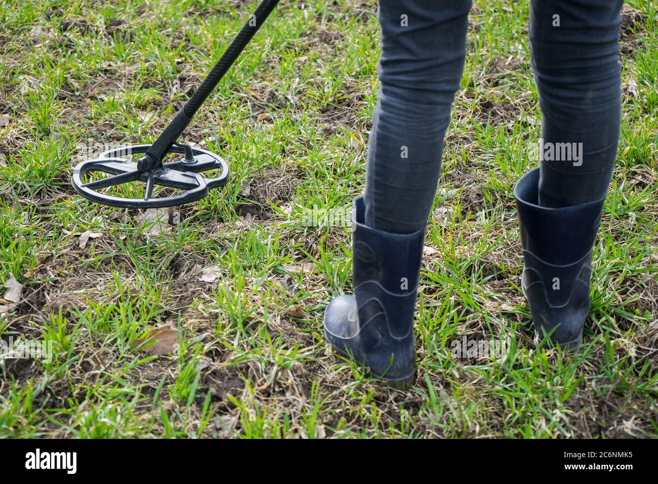 girl archaeologist or metal digger is looking for coins or metal Stock ...