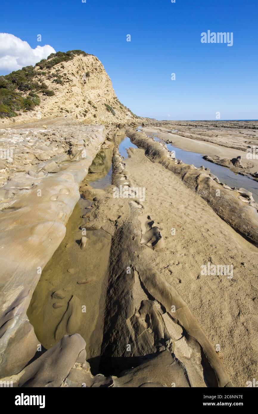 Sedimentary rocks and tide pools at the coastline in Karpas Peninsula ...