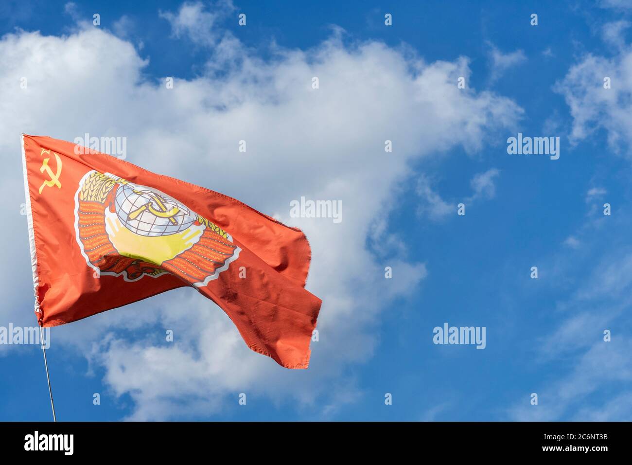 red USSR flag with soviet emblem on sky background Stock Photo - Alamy