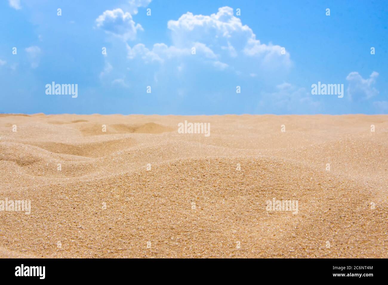 Empty sand beach in front of summer sea with copy space. Blue sky and ...