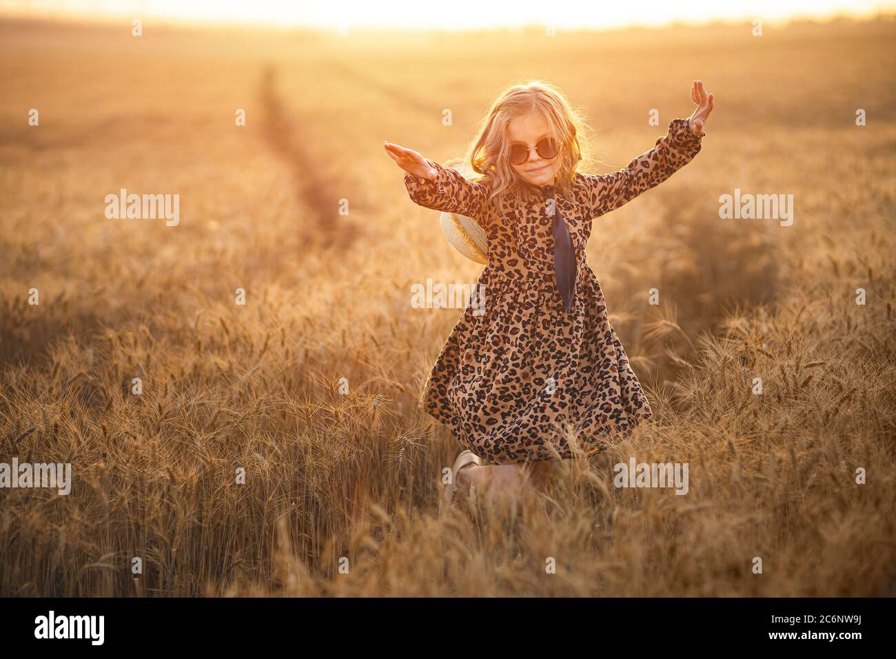 Fashion photo of a little girl in leopard print dress, sunglasses and ...