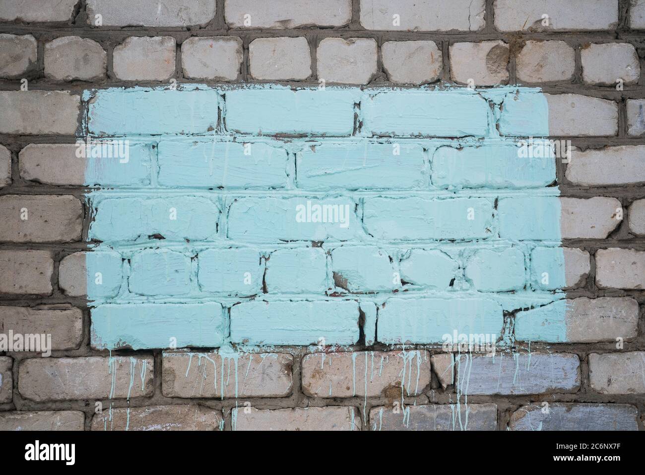 blue rectangle on a brick wall. Colored place for text Stock Photo - Alamy
