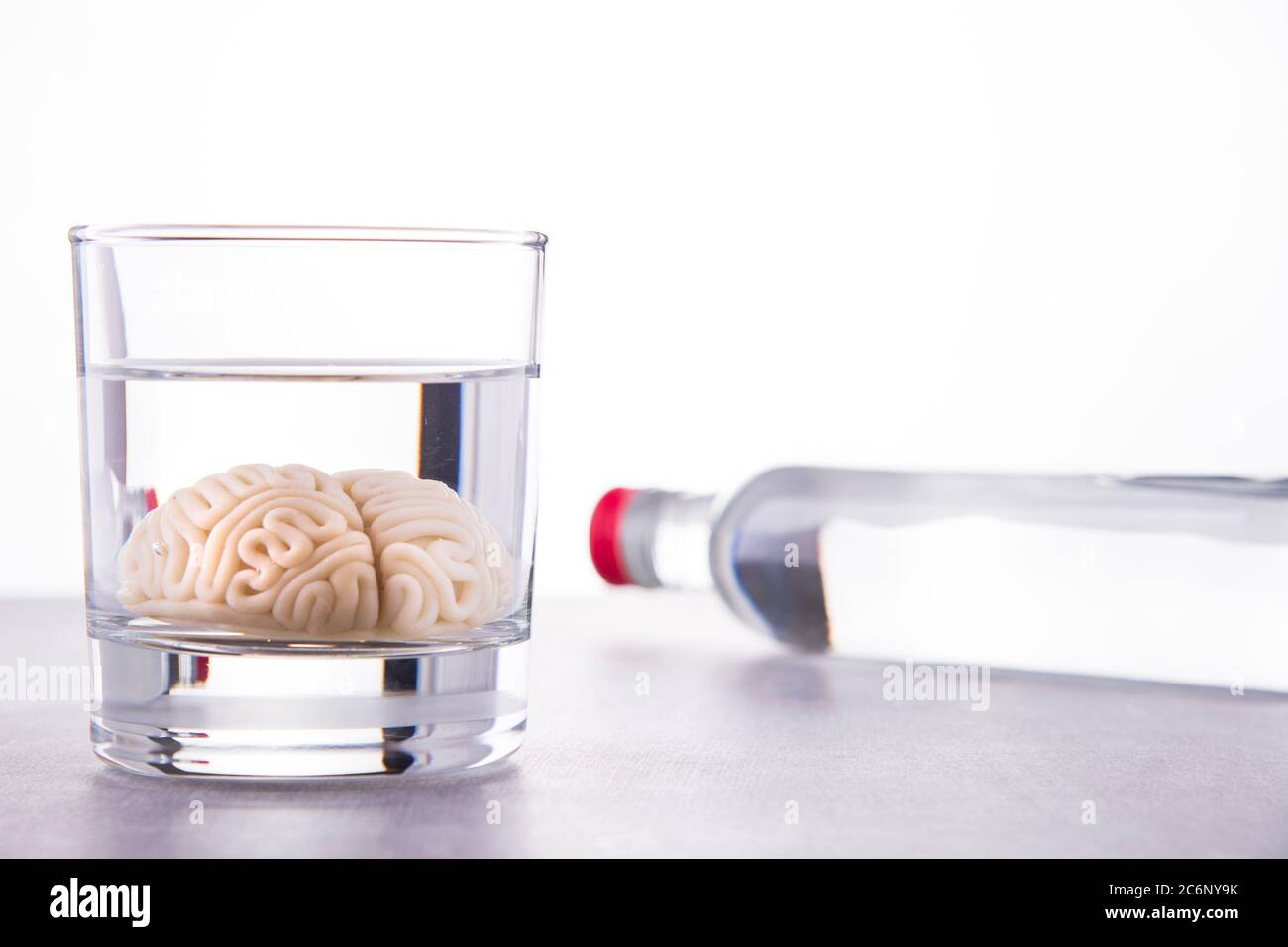 Alcohol addiction concept. Brain drowned in alcohol. Reduce IQ after ...