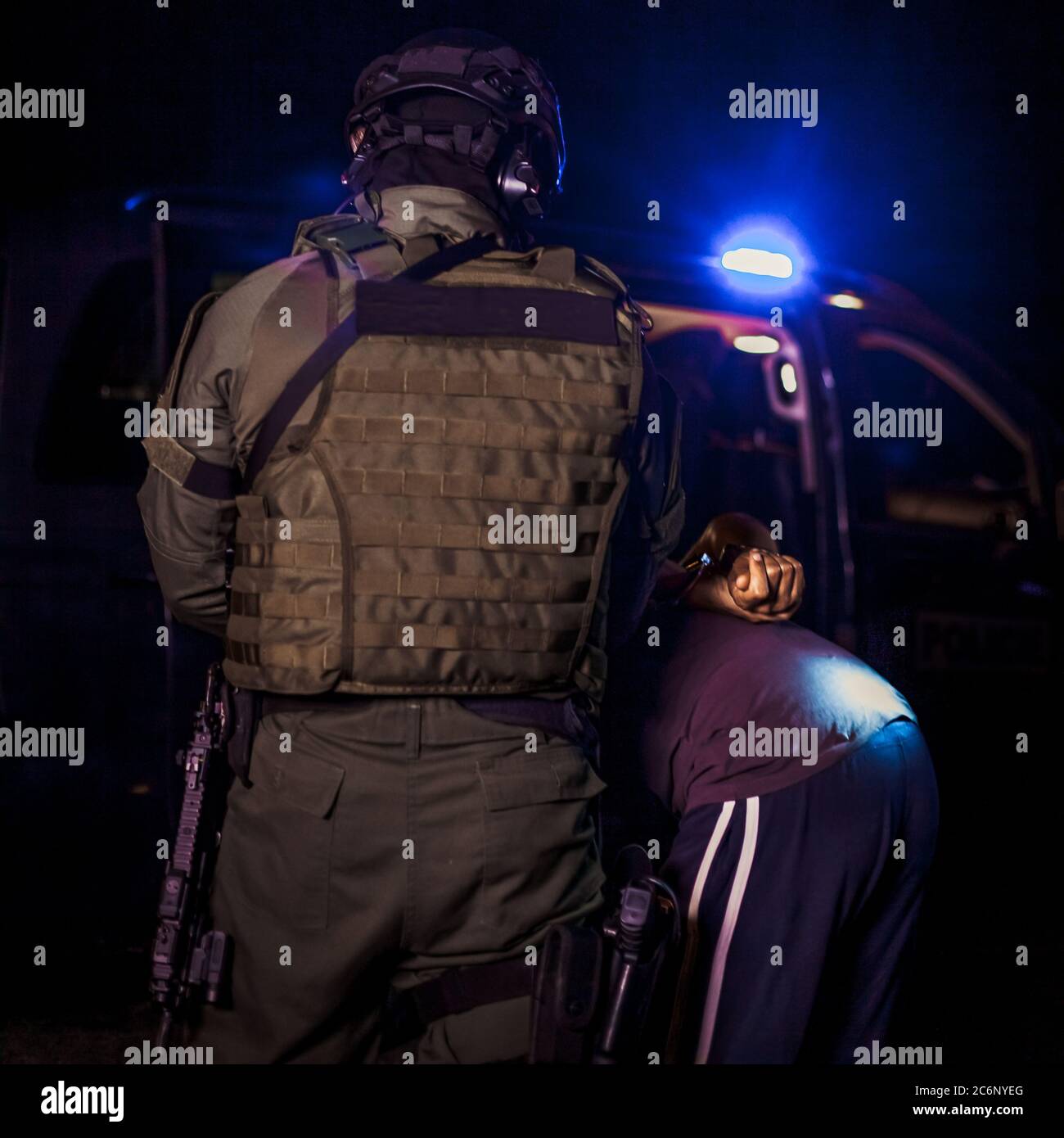 A police officer puts handcuffs on a criminal's hands during an arrest ...