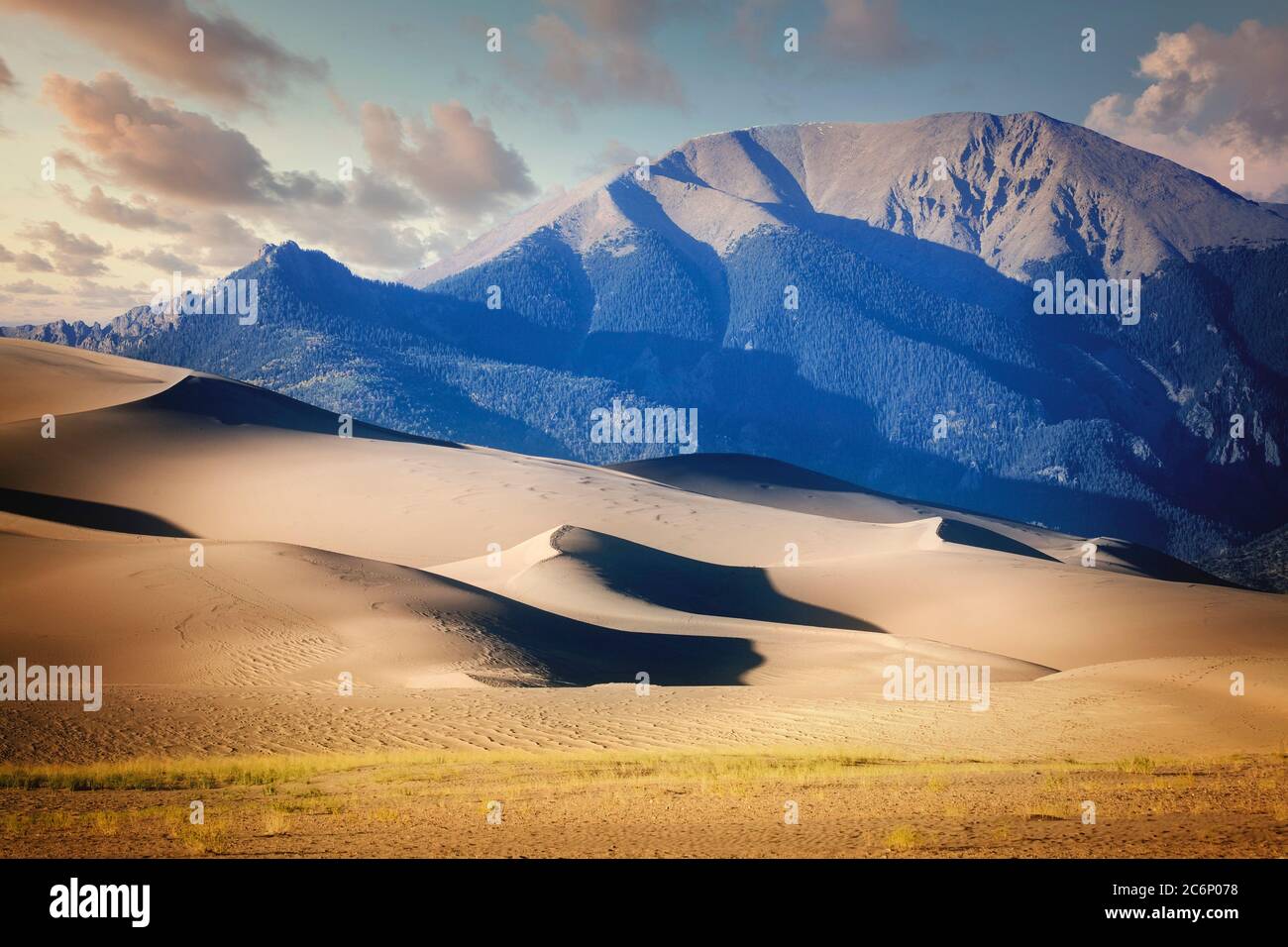 Sand moved by wind collects up against the Rocky Mountains forming ...
