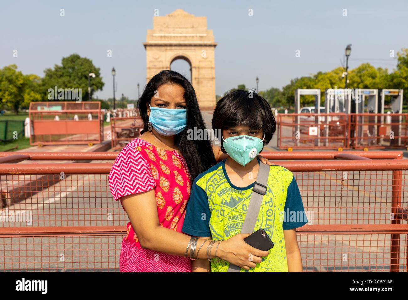 An Indian woman and her son pose infant of the iconic India Gate while ...