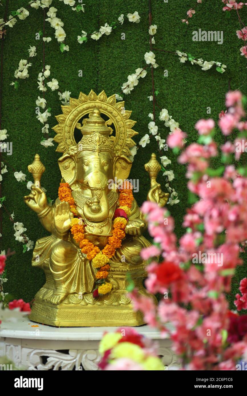 Decorative Lord Ganesha gold idol Stock Photo - Alamy
