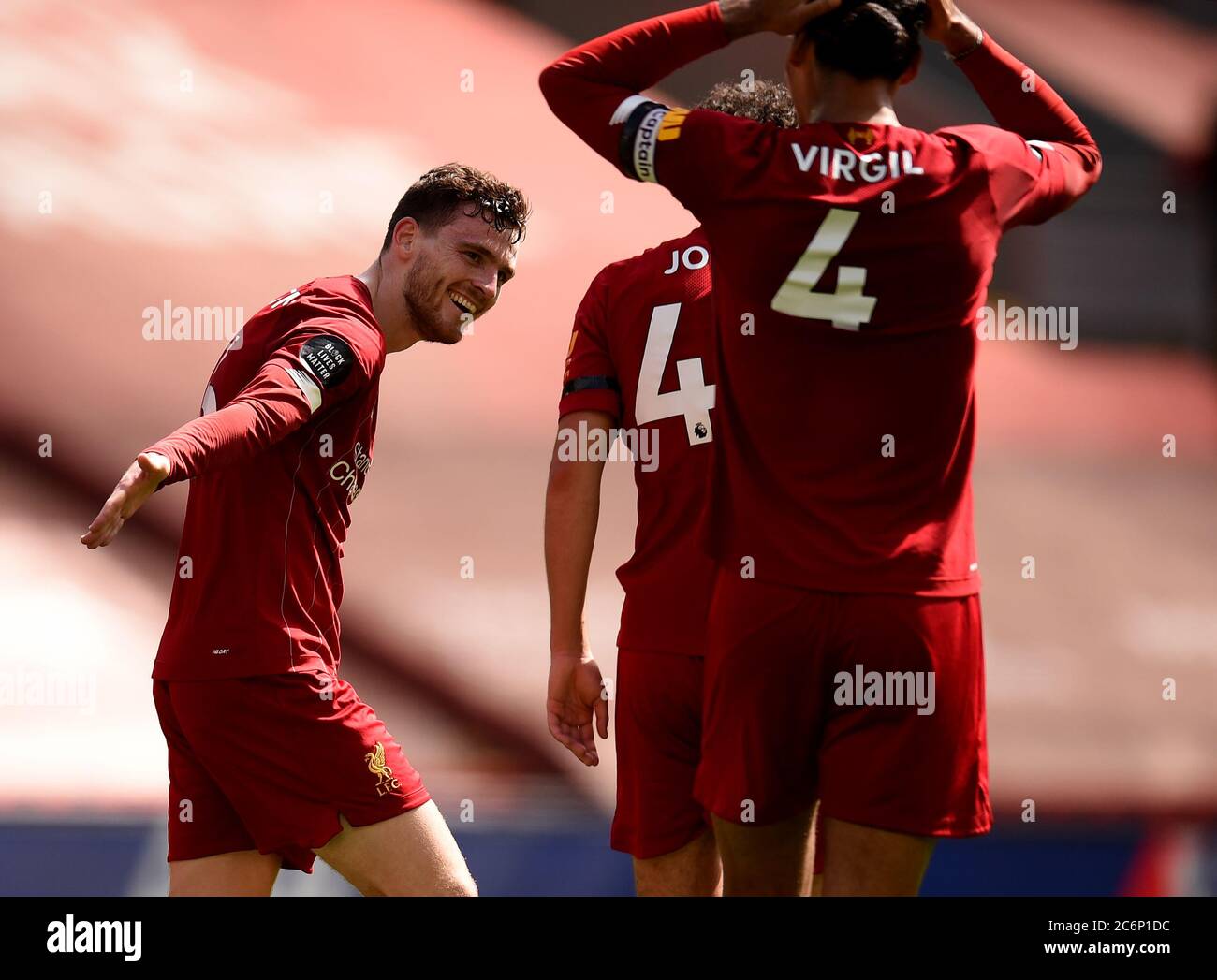 Liverpool's Andrew Robertson celebrates scoring his side's opening goal ...