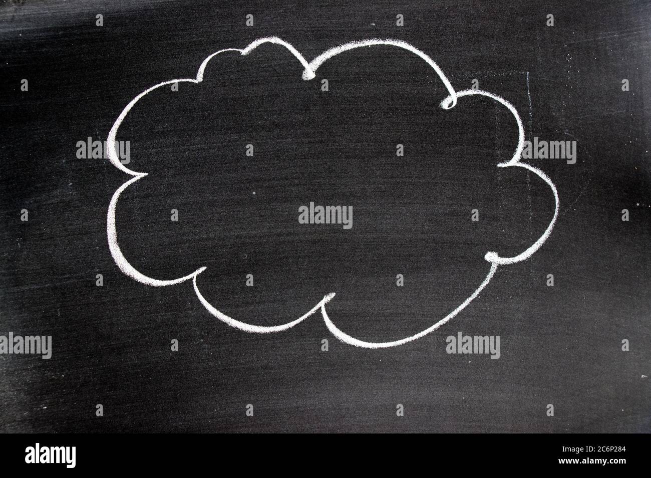 White color chalk drawing as blank speech bubble shape on blackboard ...