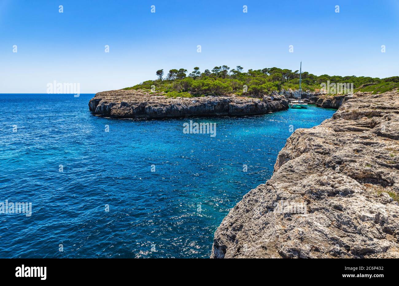Catamaran at idyllic bay on Majorca island, Mediterranean Sea Spain ...