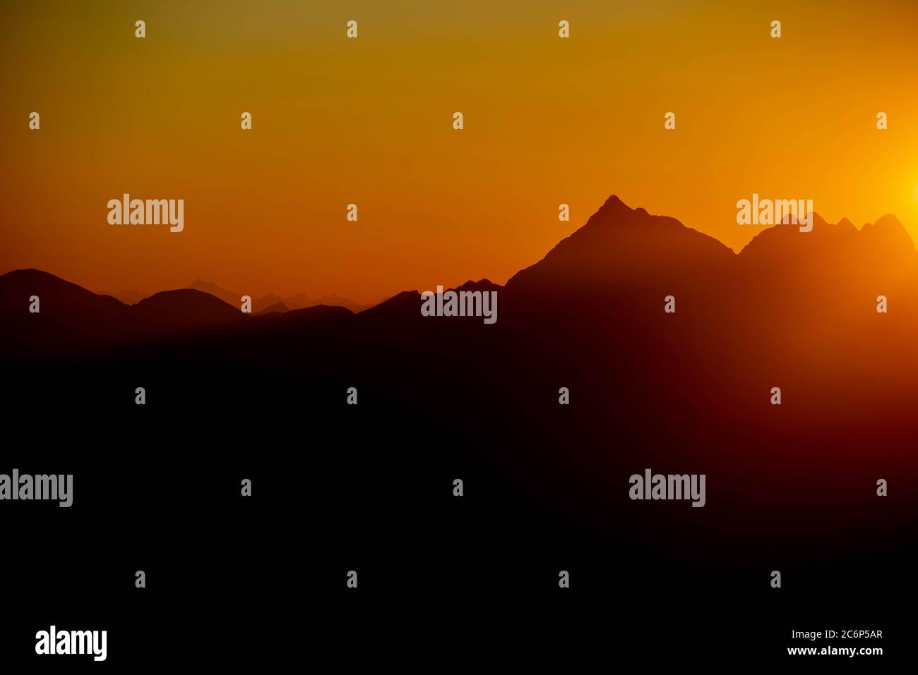 sunset over the mountains of lombardy Stock Photo - Alamy