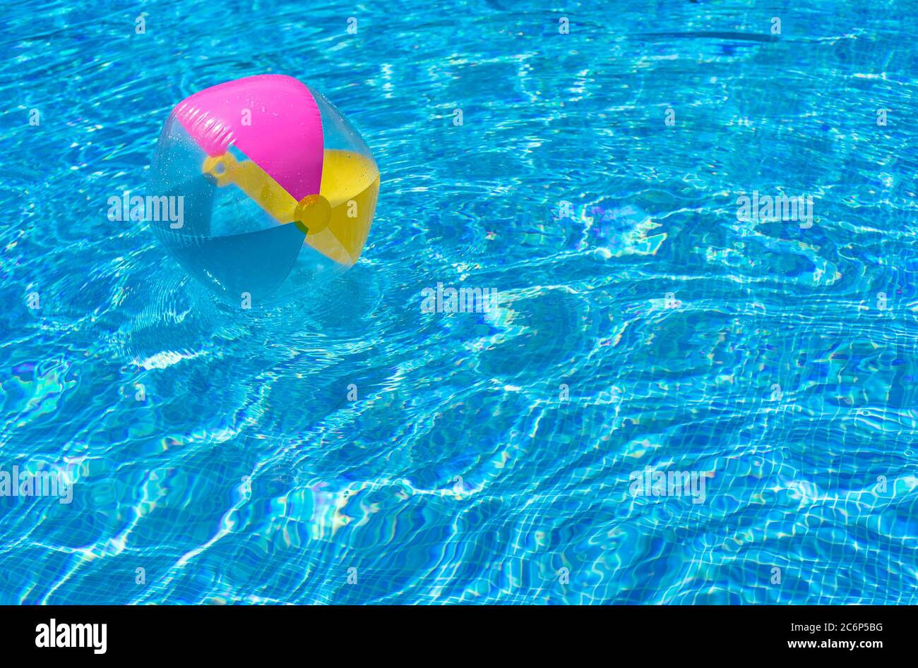 Summer holiday background, inflatable beach ball float on swimming pool ...