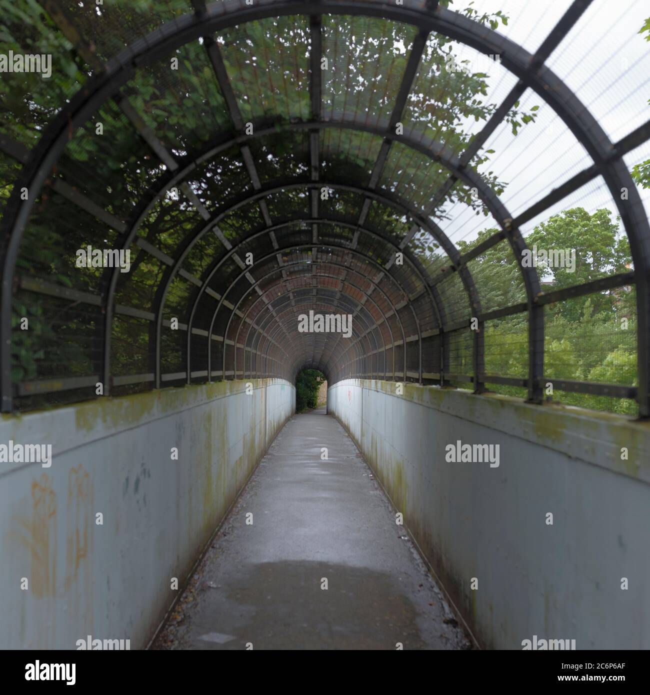 An enclosed pedestrian bridge over railway tracks, London, England ...