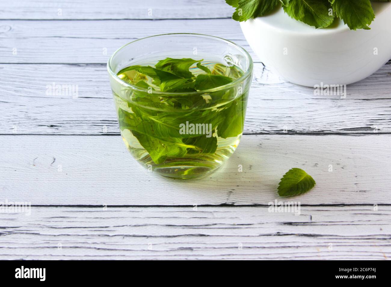 Fresh mint tea concept on a wooden background. Mint tea in a ...