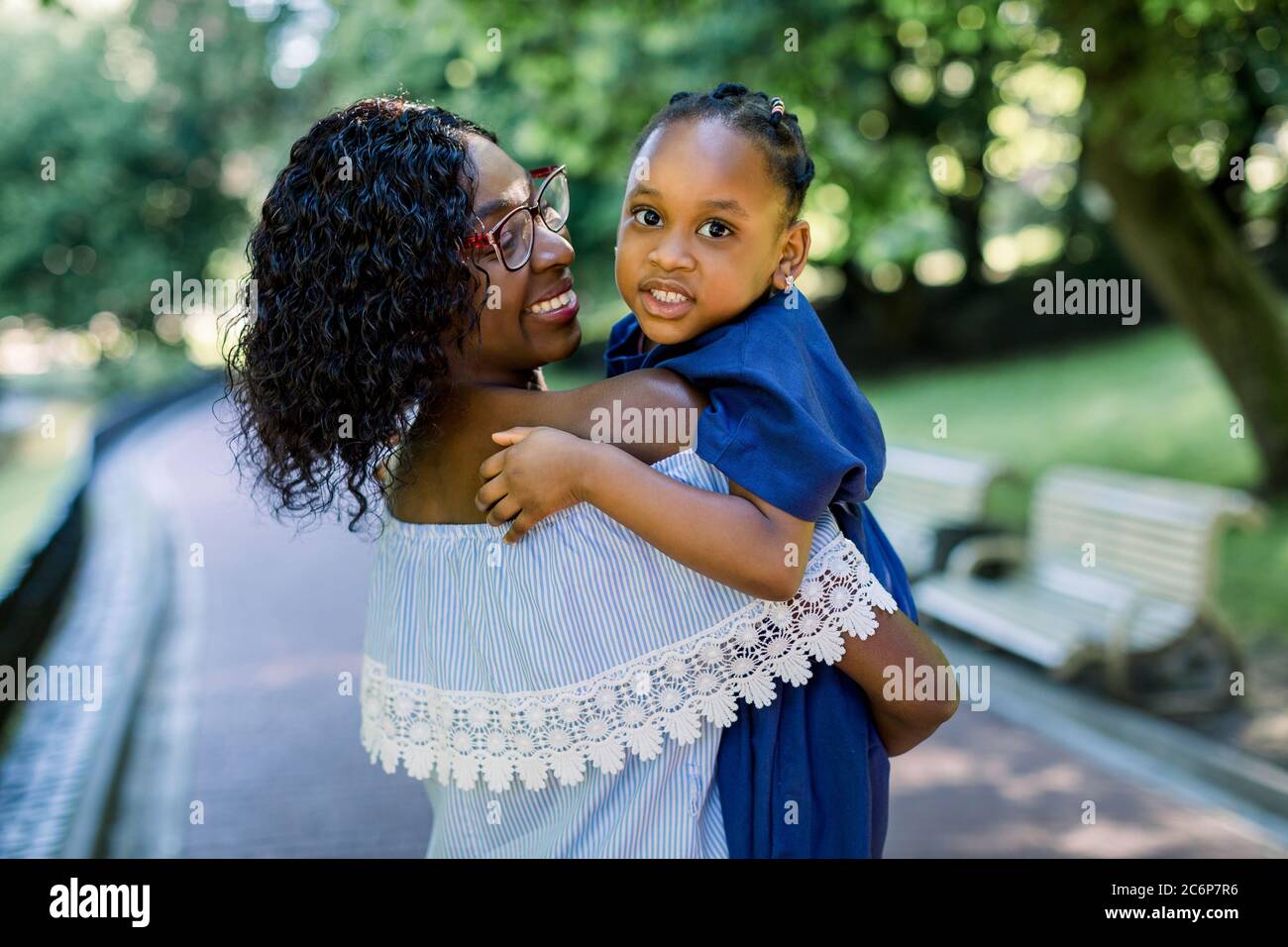 Beautiful family portrait at the summer sunny park of happy african ...