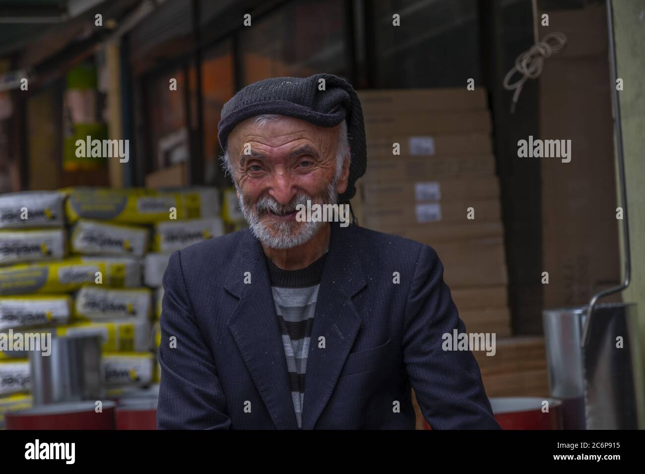 an elderly turkish smile during his work in construction shop in Turkey ...