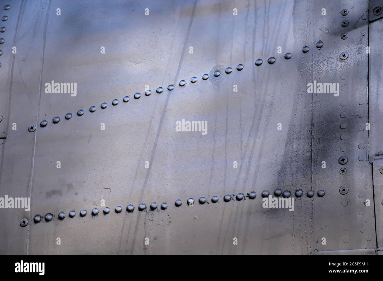 Aircraft skin close up. Rivets on gray metal. Background for design ...