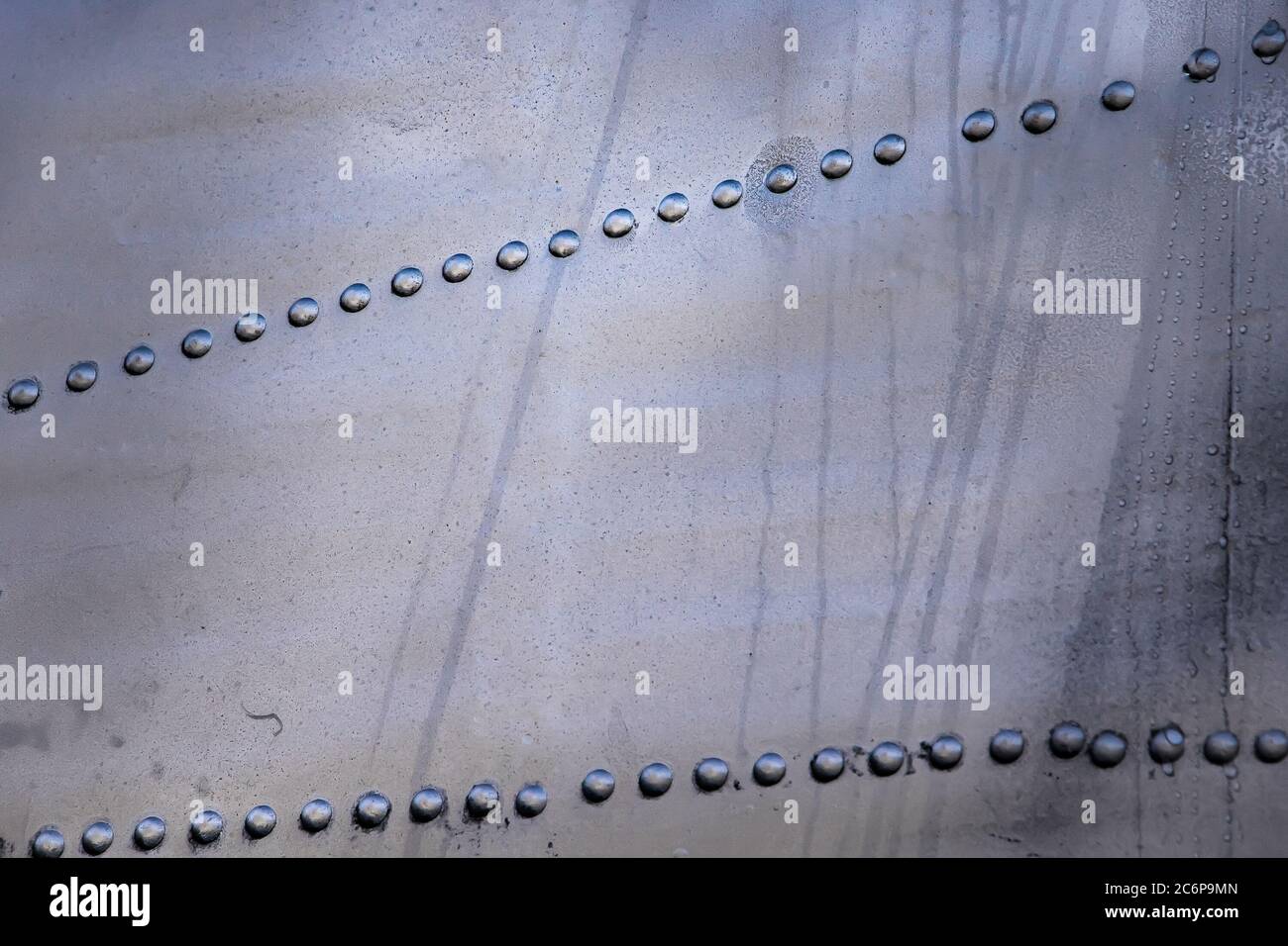 Aircraft skin close up. Rivets on gray metal. Background for design ...