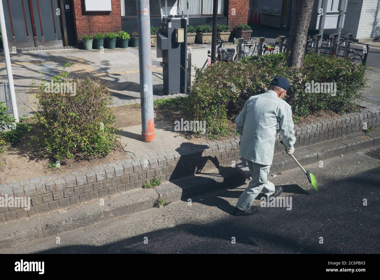 Man cleaning street, city of Osaka Japan Stock Photo - Alamy