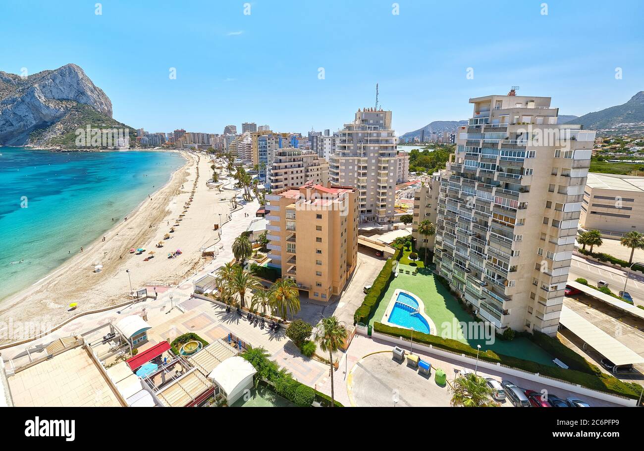 Sandy beach with parasols and vacationers, Penyal d'Ifac Natural Park ...