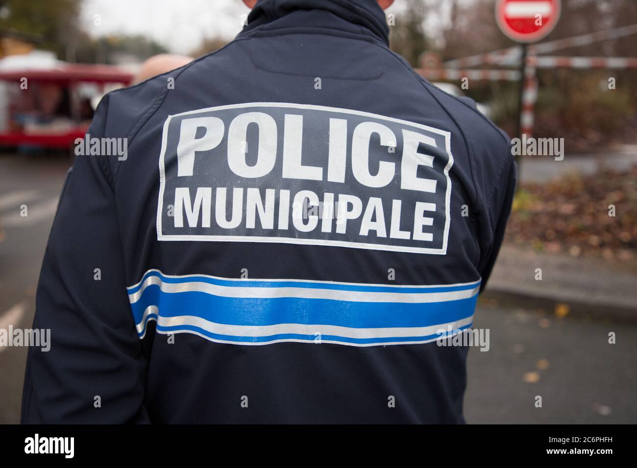 back view of french policeman police municipal means local police in ...