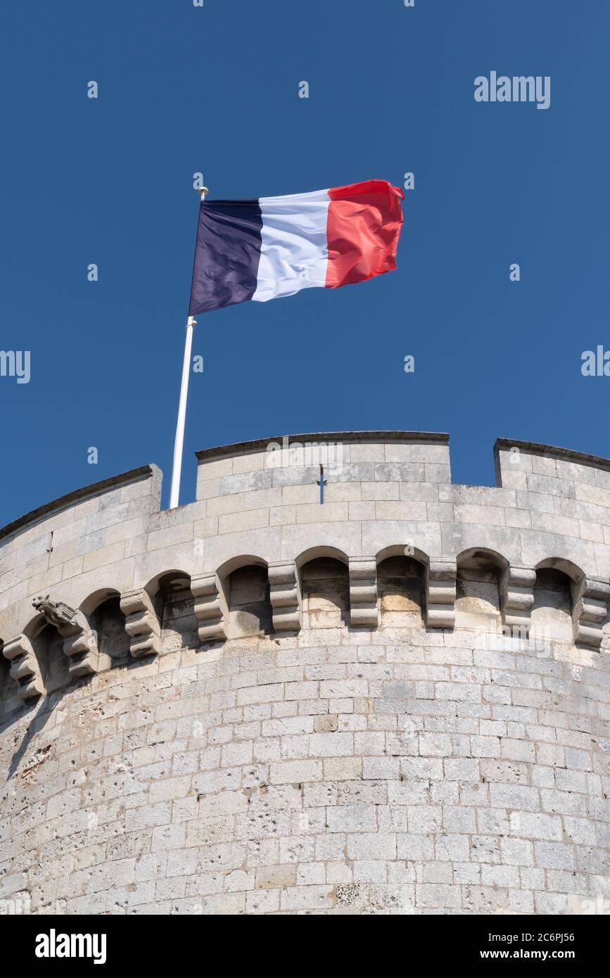 Flag of France waving over a blue sky in La Rochelle city in western ...