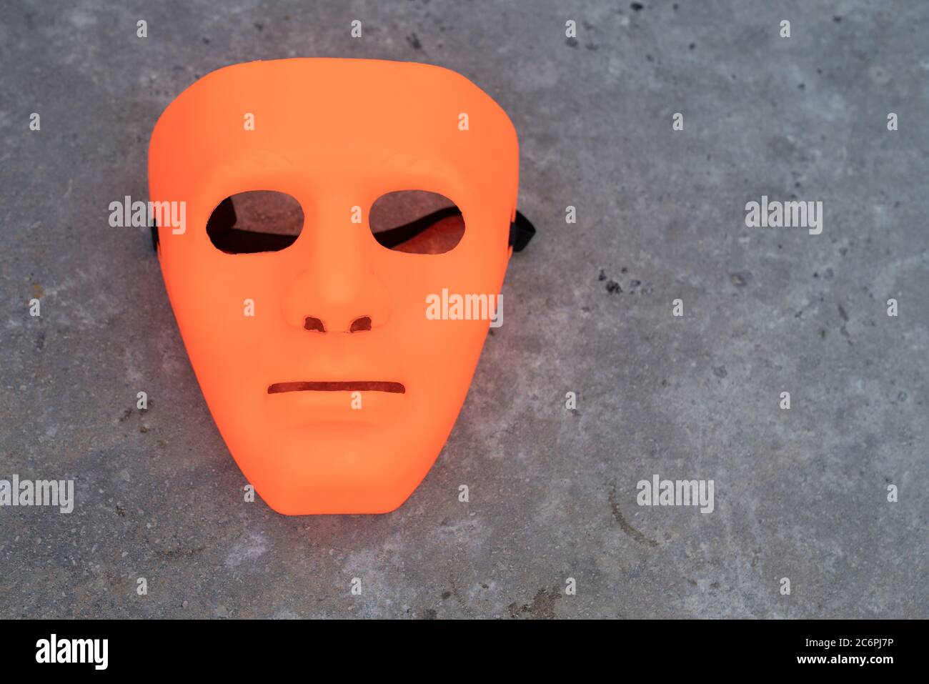 Full Face empty Orange Mask Alien in grey stone background halloween ...