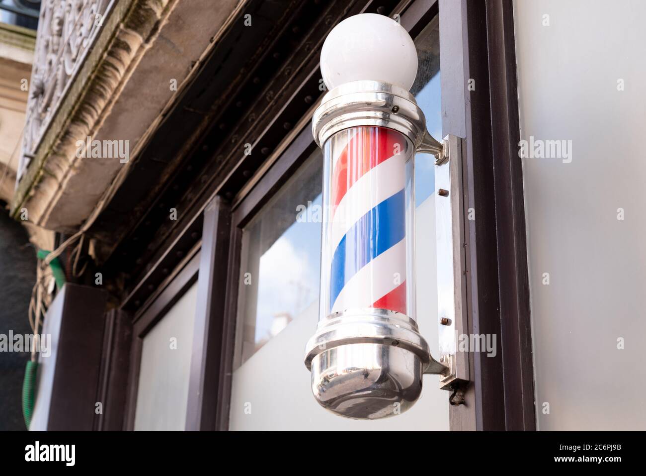 Classic vintage Barber shop pole in the street Stock Photo - Alamy
