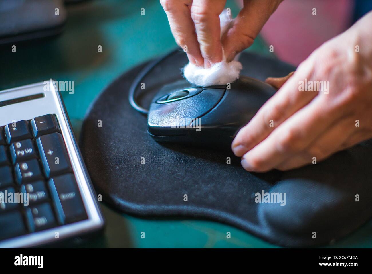 sanitizing computer mouse with alcohol Stock Photo - Alamy