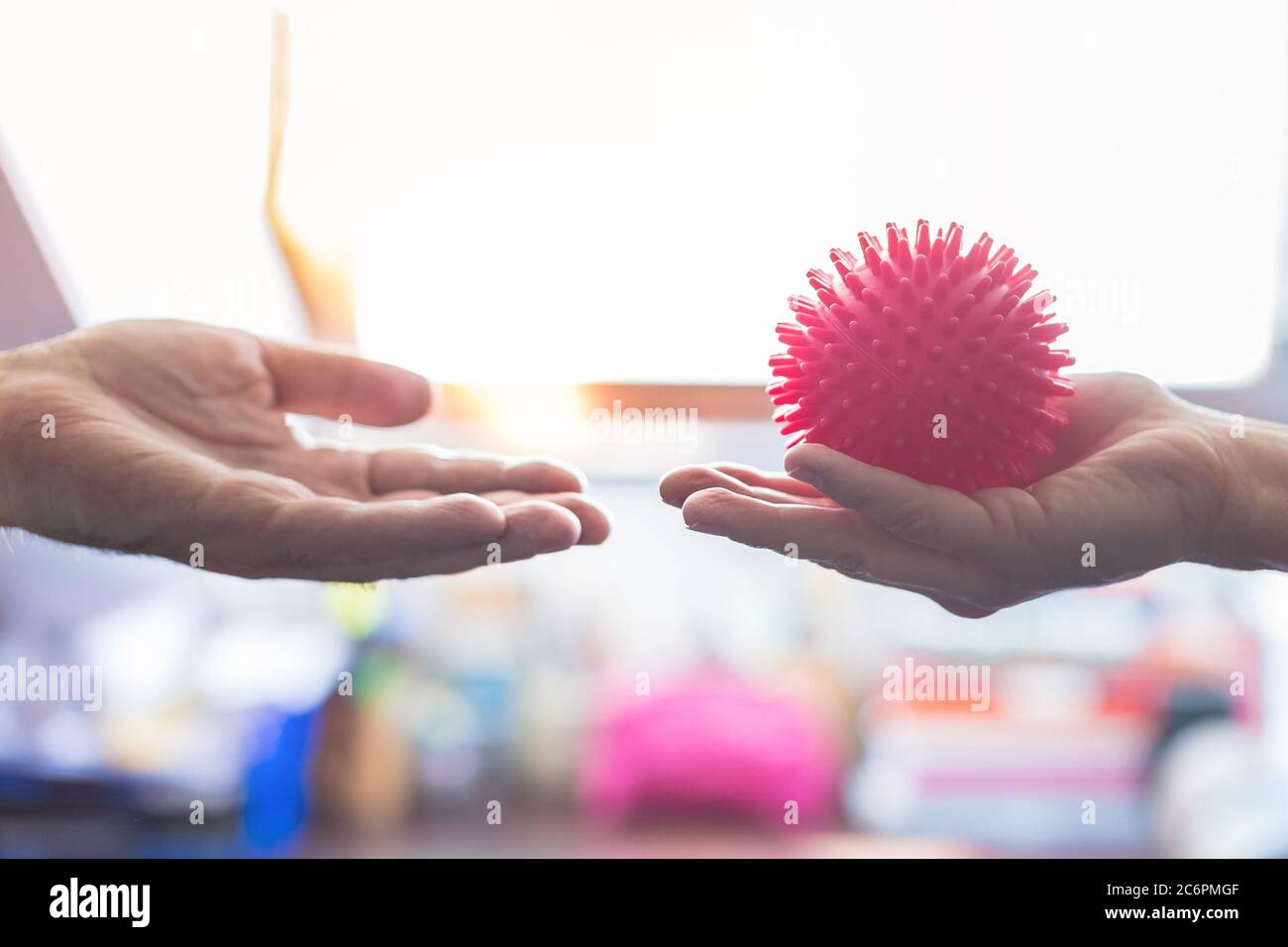 handing over a spike massage plastic ball from hand to hand Stock Photo ...