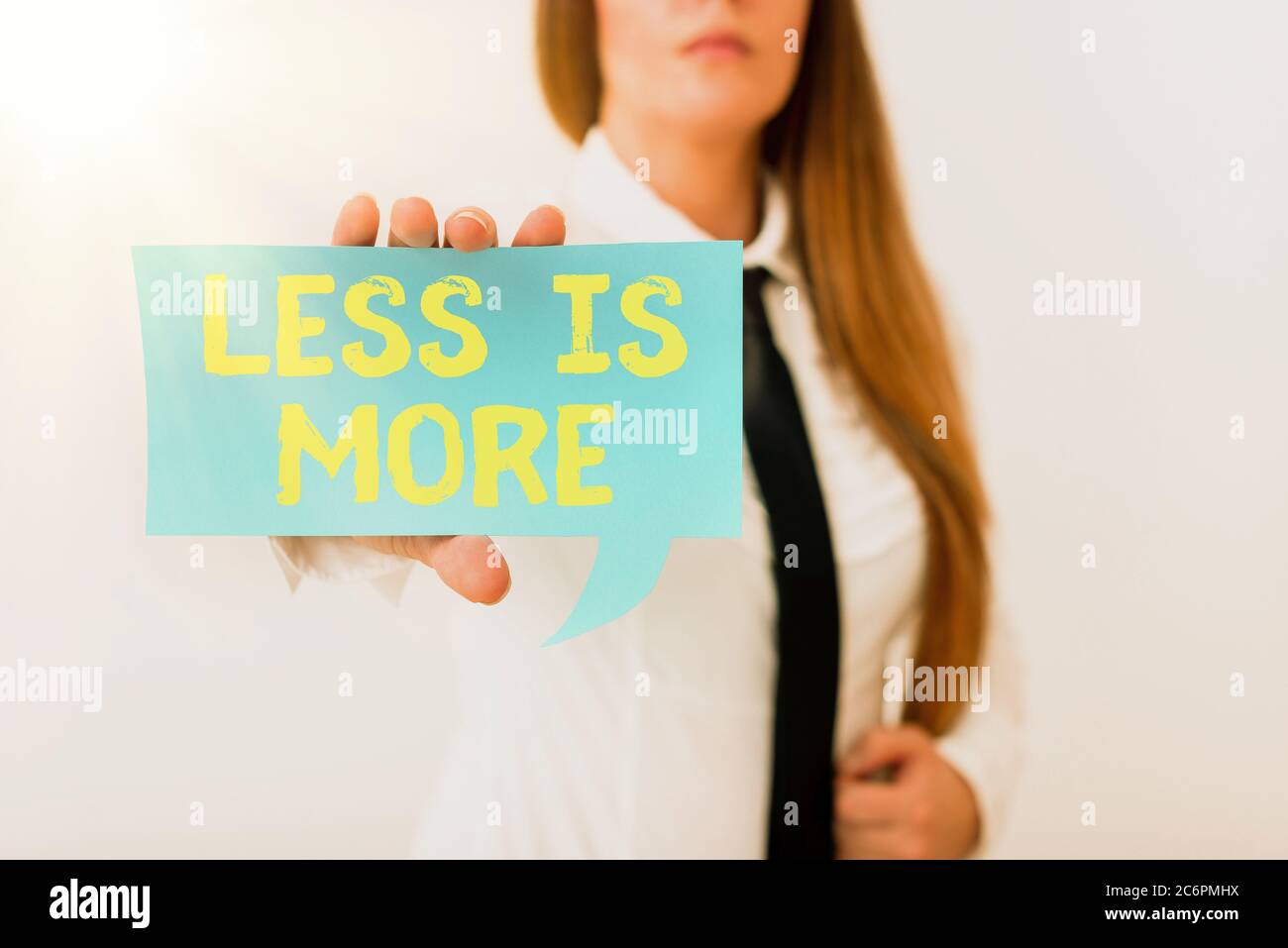 Writing note showing Less Is More. Business concept for used to express ...