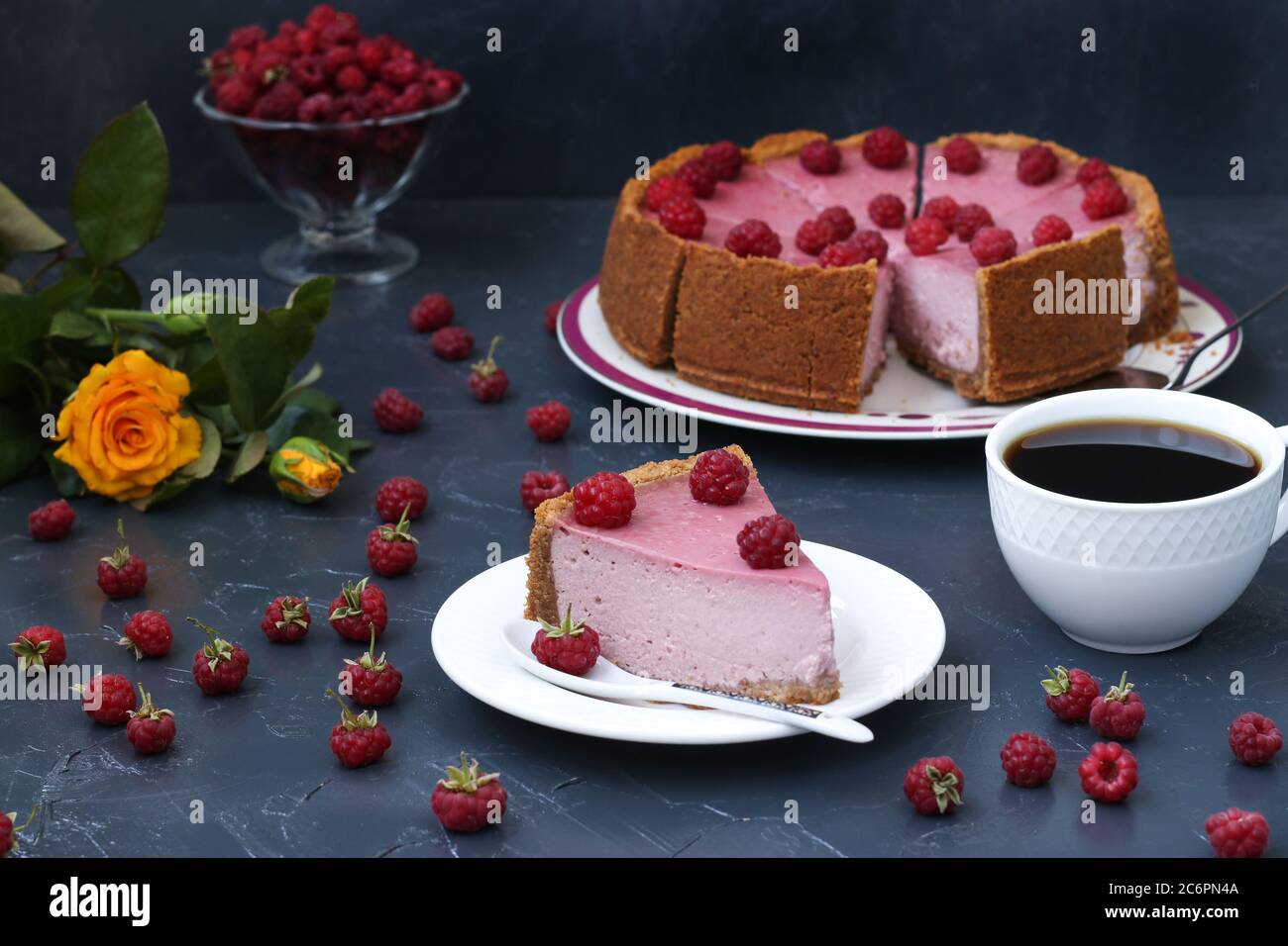 Chopped homemade raspberry cheesecake in portions on a plate, located ...