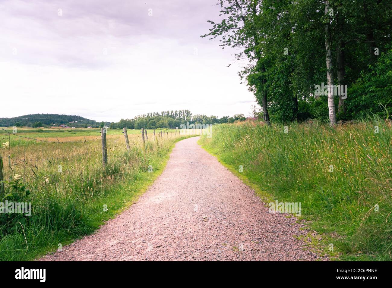 Clouds wild road path fence hi-res stock photography and images - Alamy