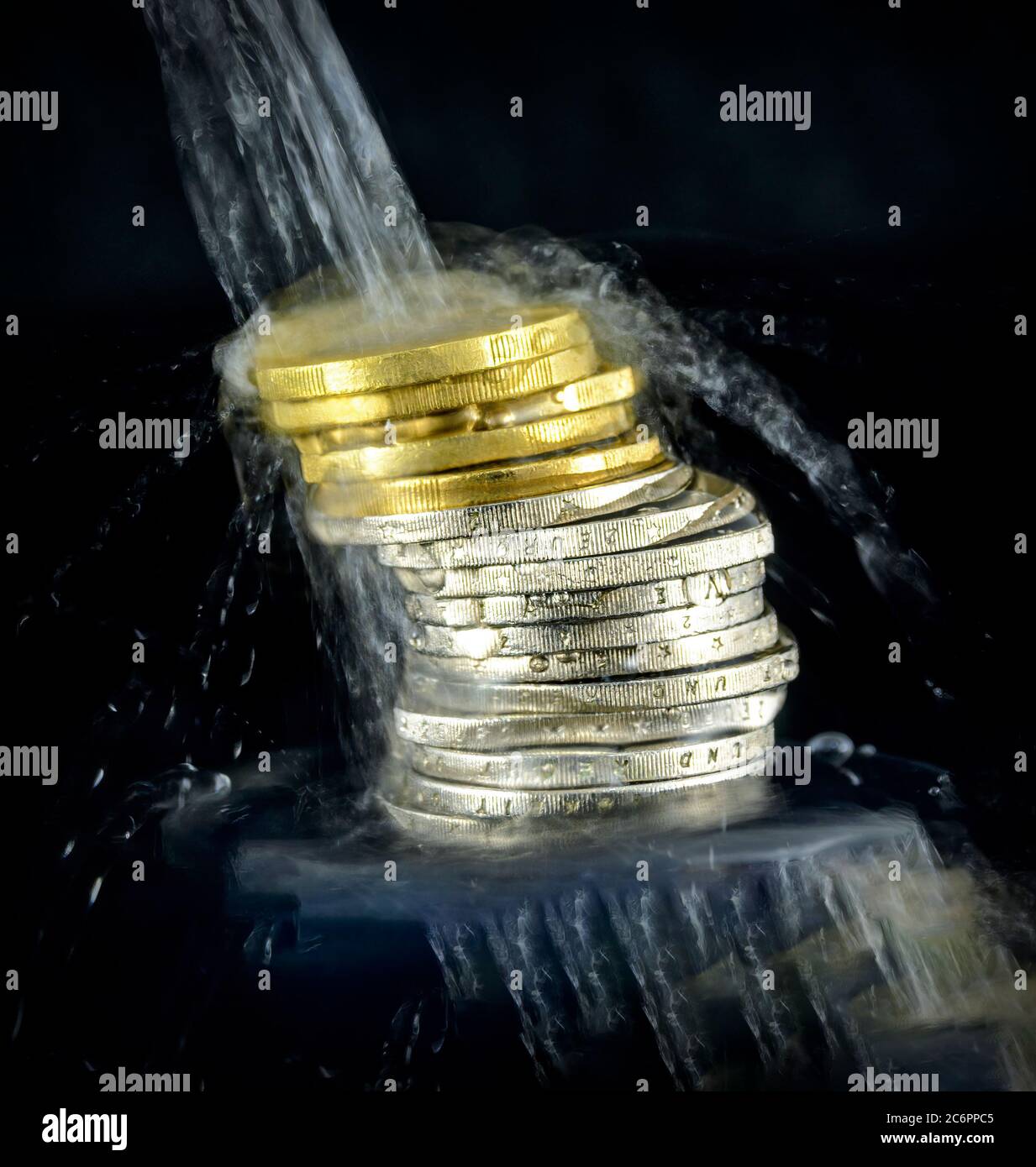 water running over a stack of Euro coins before black background Stock ...