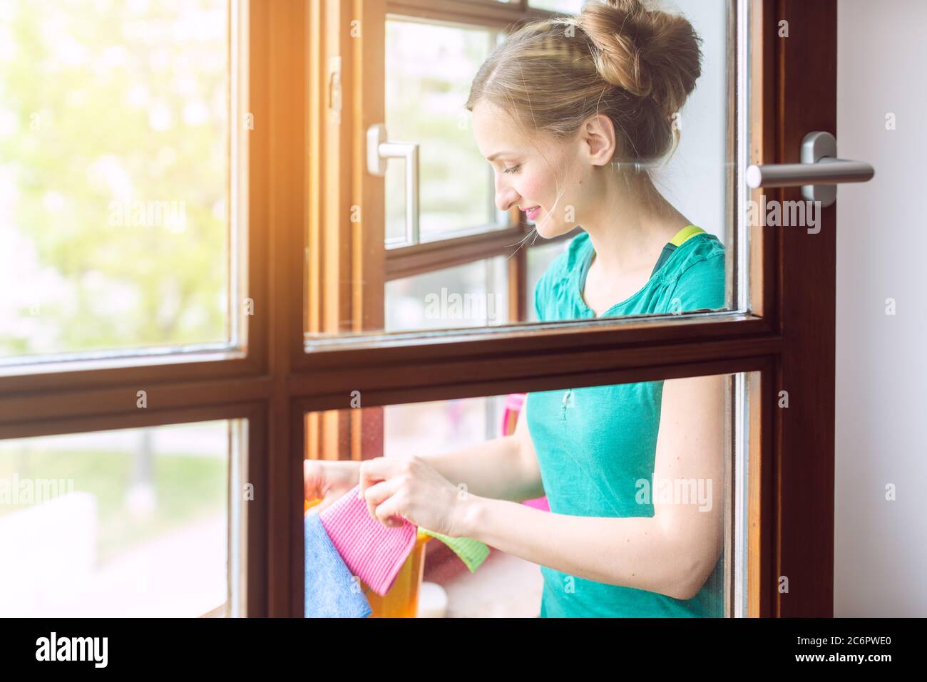Young woman washing windows hi-res stock photography and images - Alamy