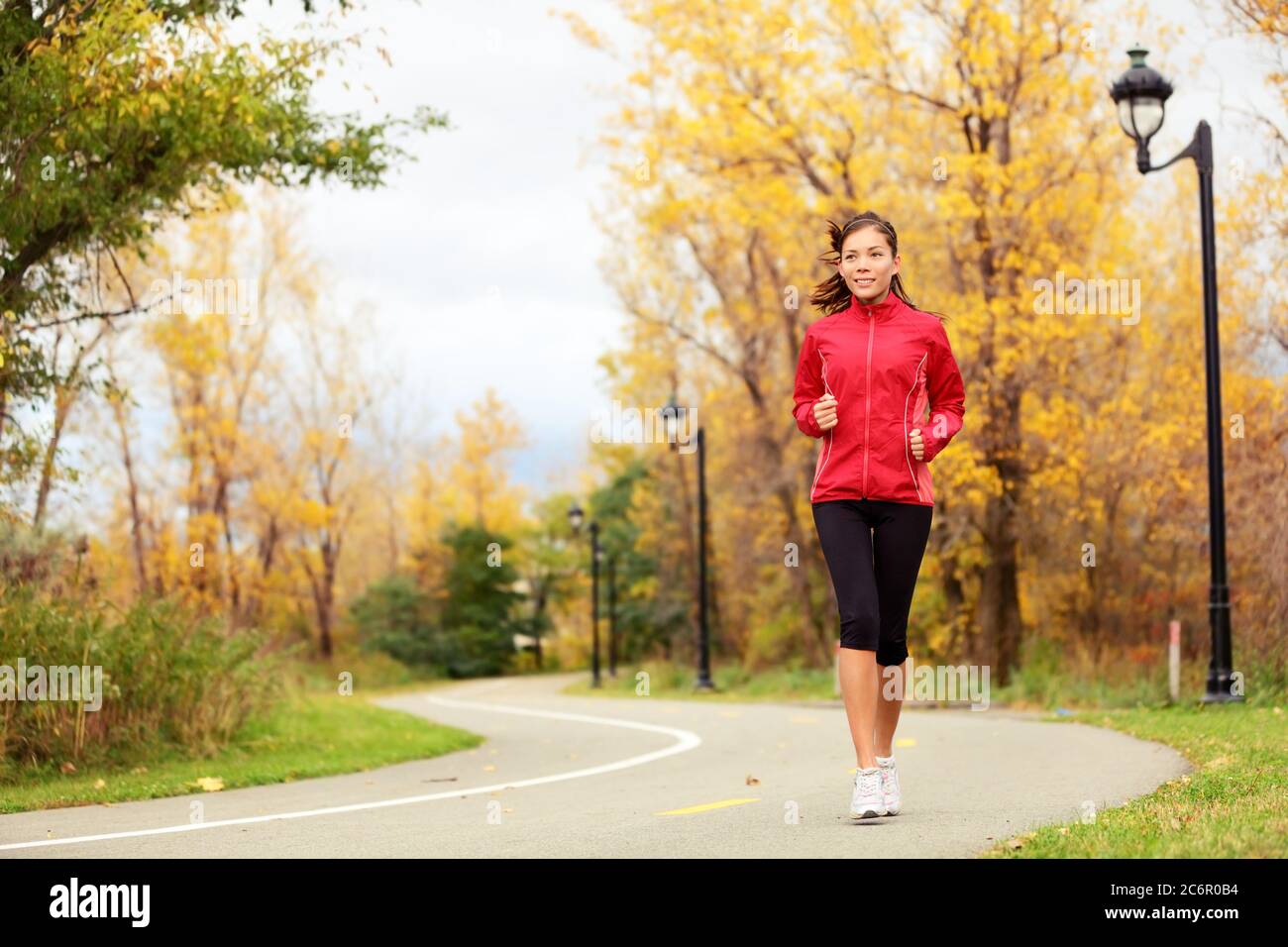 Fall running - woman jogging in autumn Stock Photo - Alamy