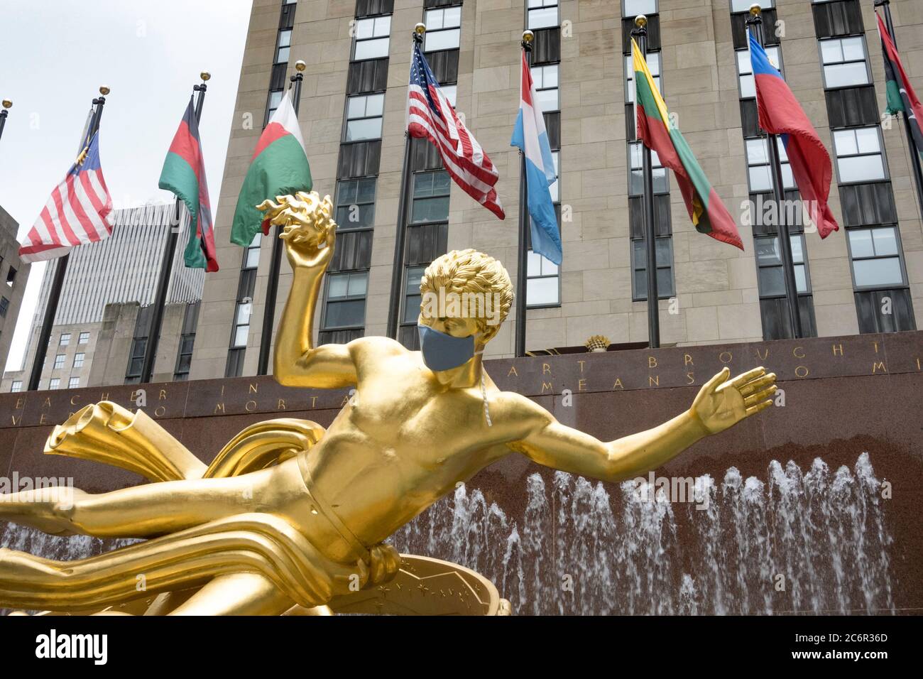 Prometheus in Rockefeller Center features a giant face mask because of ...