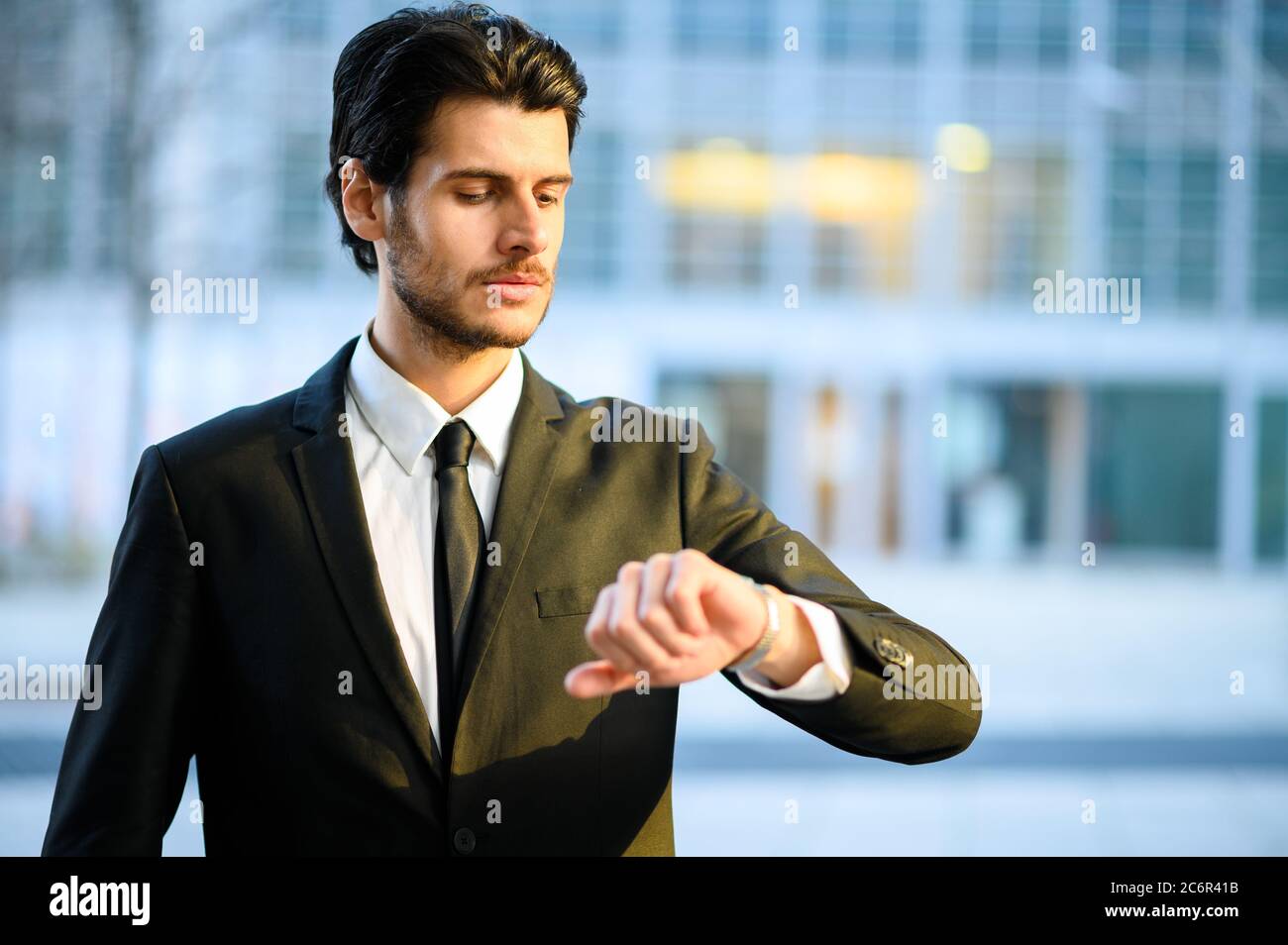 Business man watching the time Stock Photo - Alamy