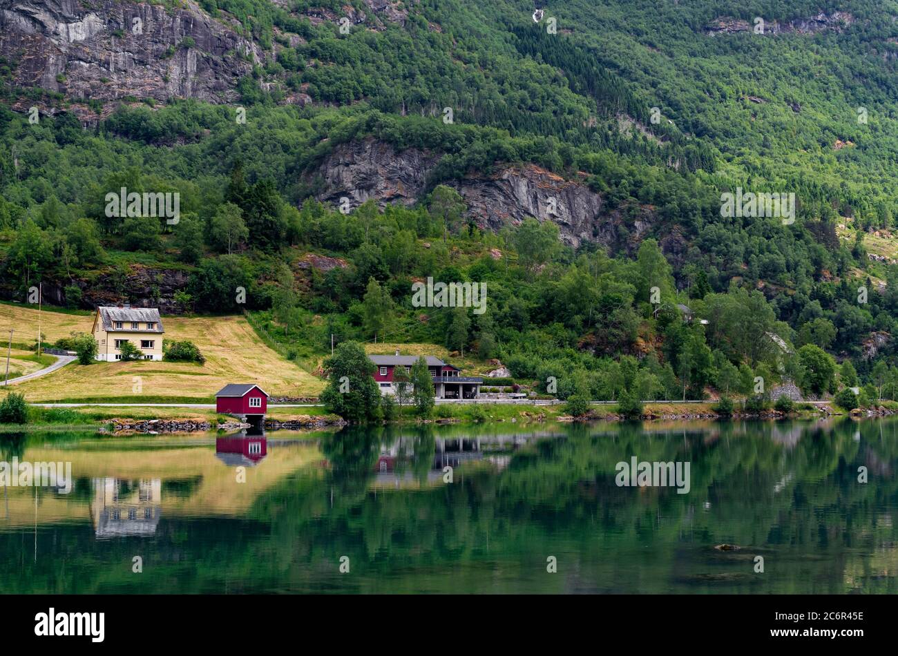 Beautiful Norwegian landscape reflected in the lake. Farm houses ...