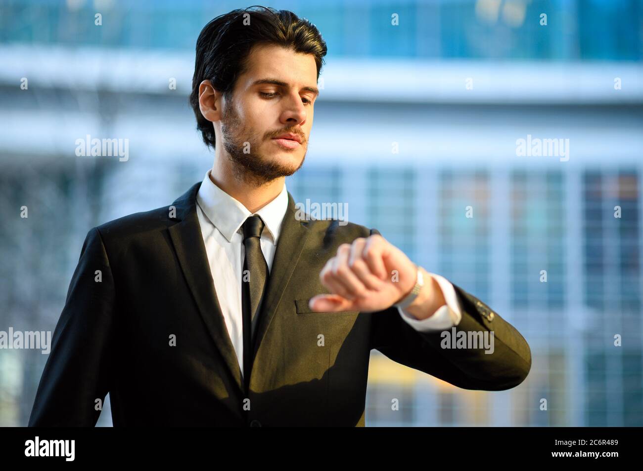 Business man watching the time Stock Photo - Alamy