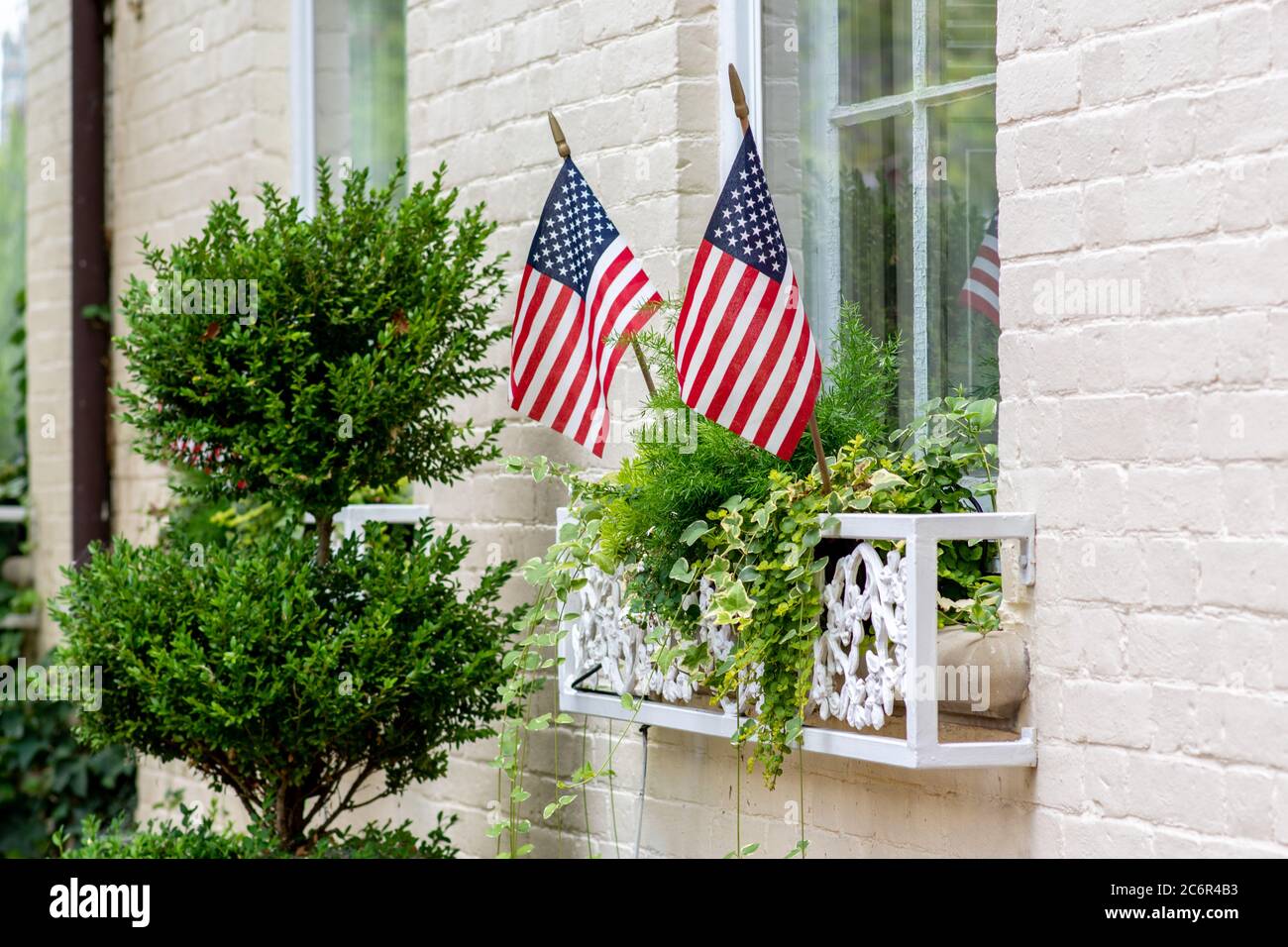 Old colonial style home with white painted bricks is adorned with ...